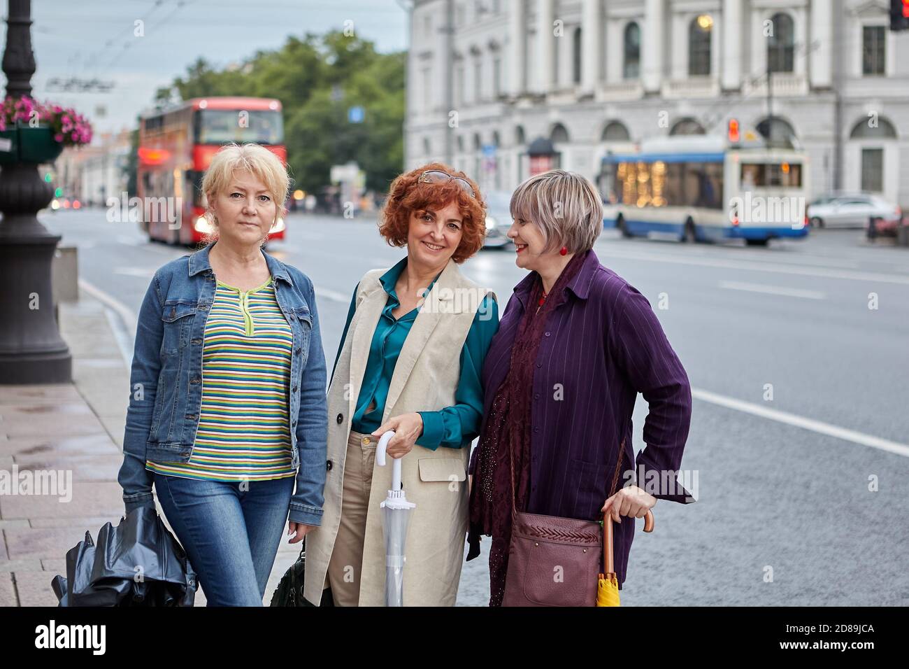 Senior pretty women walk on city street Stock Photo - Alamy