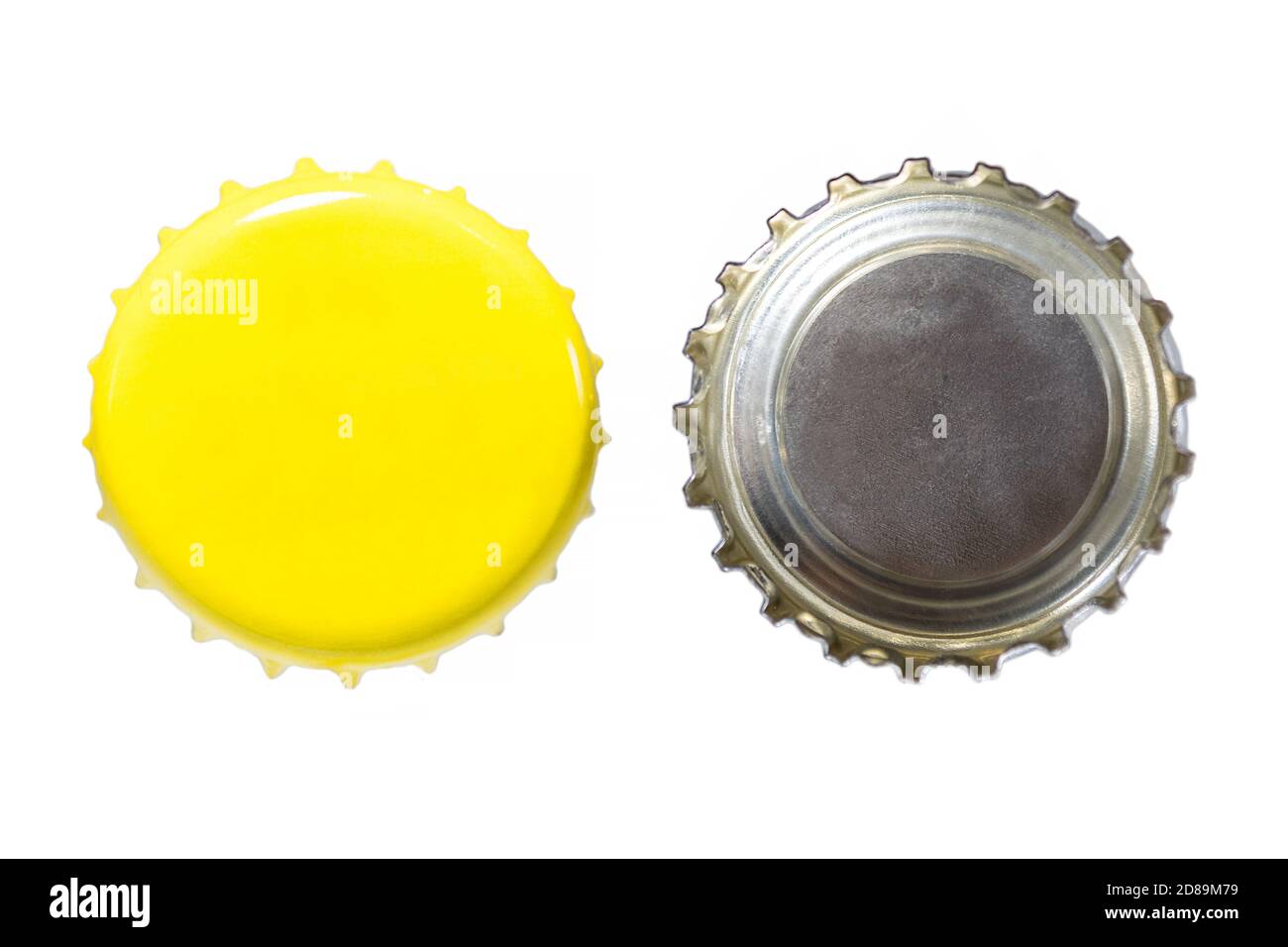 Closeup of both sides of a yellow metal bottle cap isolated on the ...