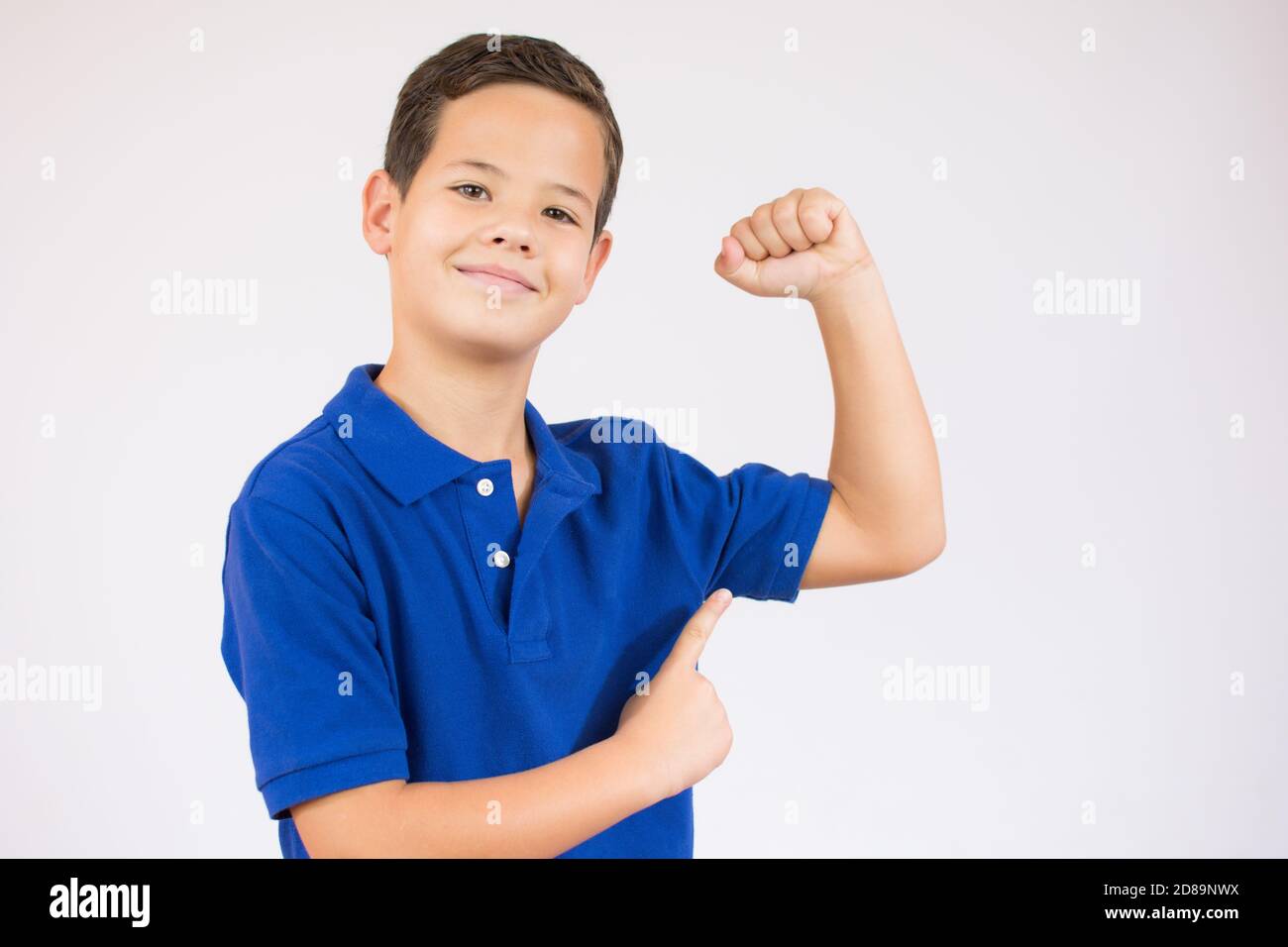 Boy is showing his arm muscles over white background Stock Photo - Alamy
