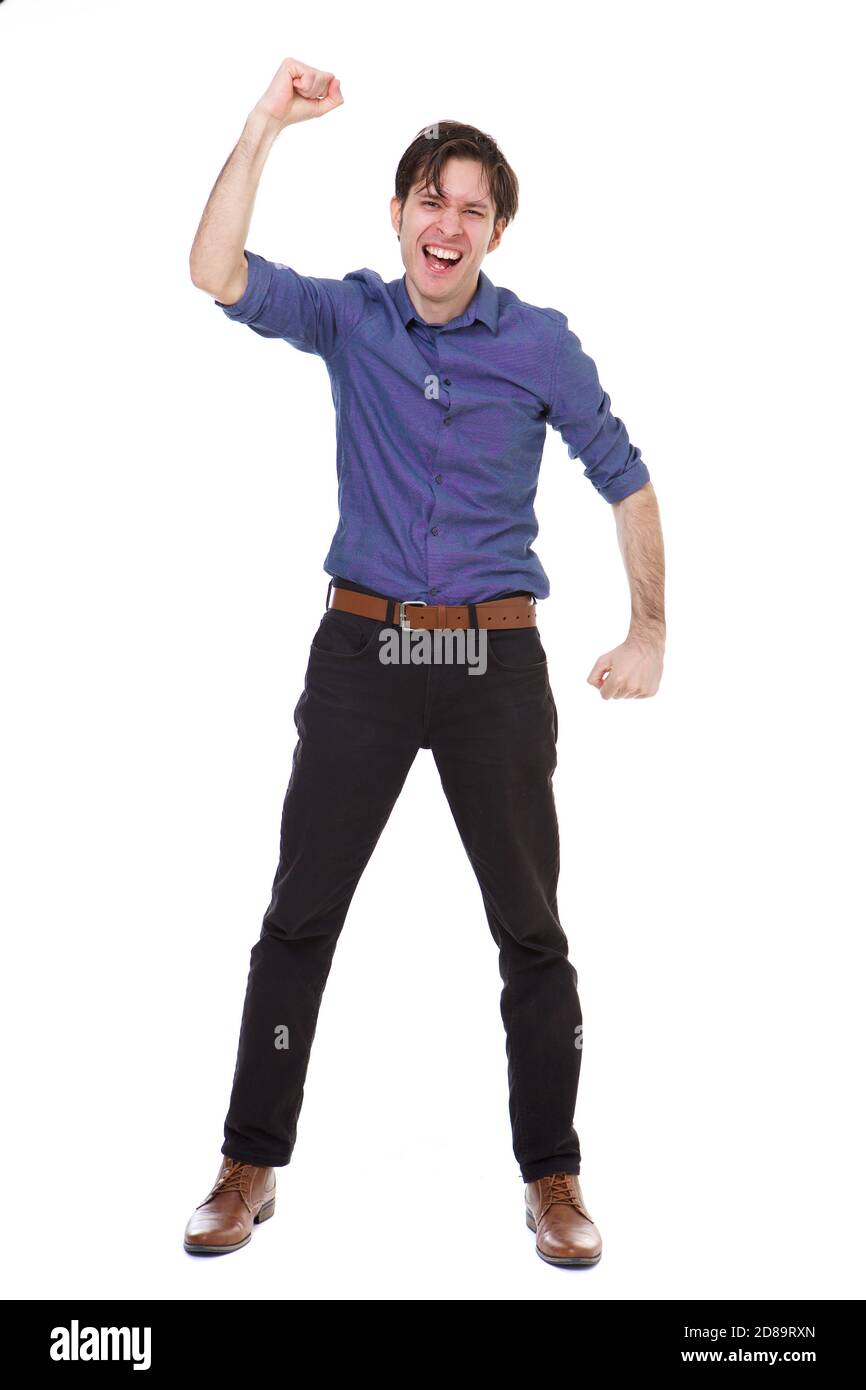 Full length portrait of ecstatic young man standing with fist raised ...