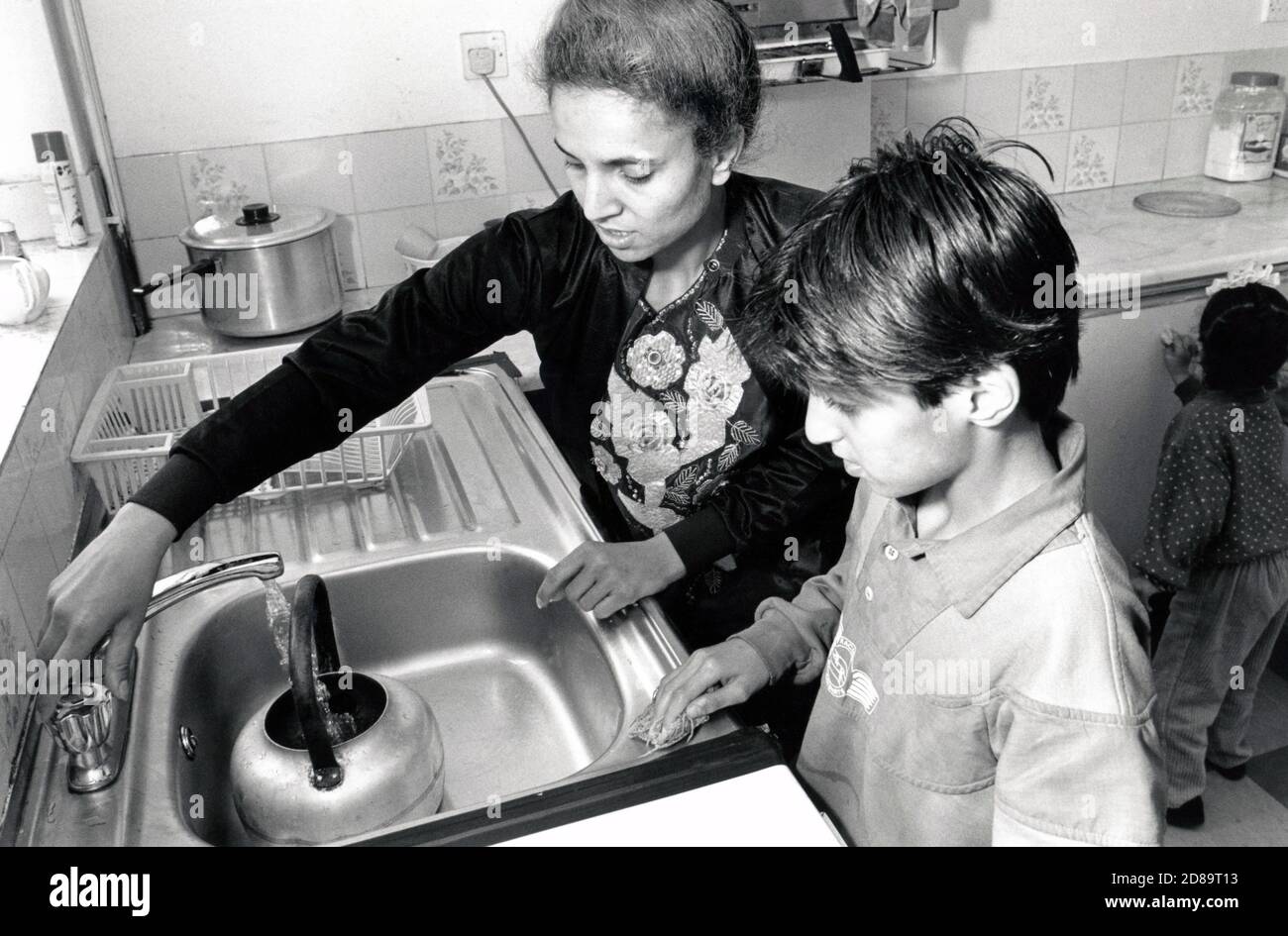 Boy helping mother with chores hi-res stock photography and images - Alamy