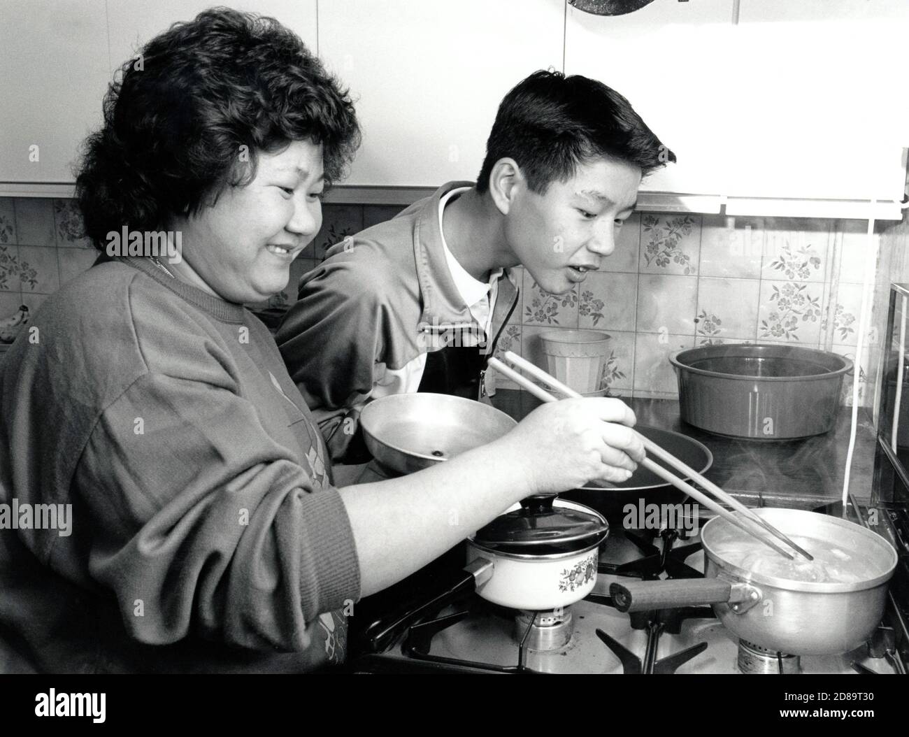 Vietnamese mother & son cooking, Carlton, Nottingham UK 1990 Stock ...