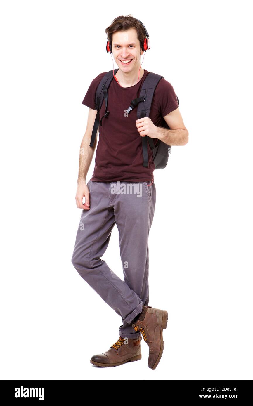 Full length portrait of cool college student with earphones listening ...