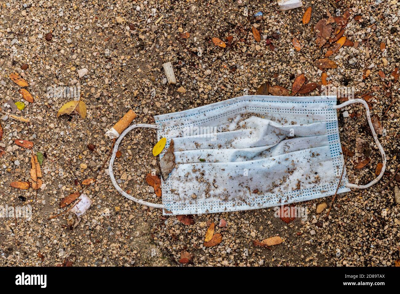 hygienic mask thrown on a dirty floor Stock Photo - Alamy