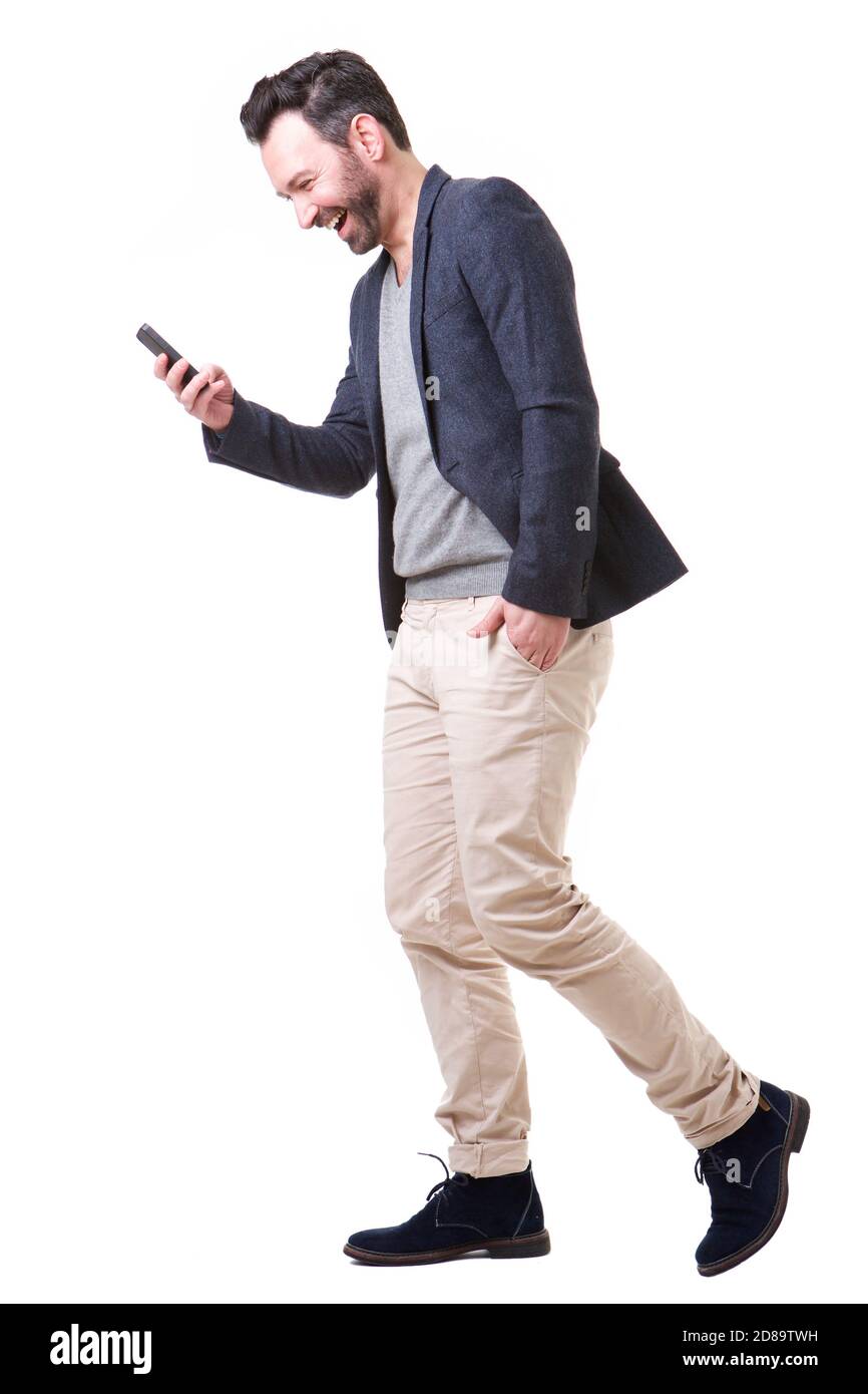 Full length side portrait of happy man looking at cellphone Stock Photo ...