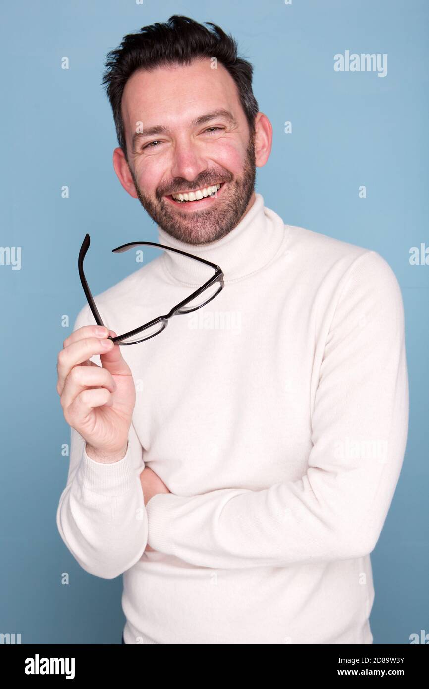 Portrait Of Happy Man Posing Against Blue Background With Glasses Stock