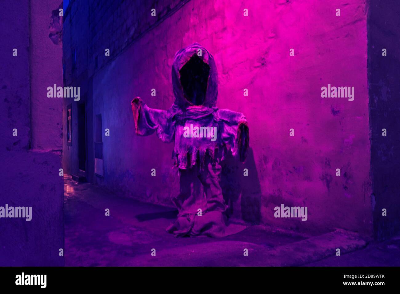 Silhouette of scary mythical ghost against wall with duotone ...