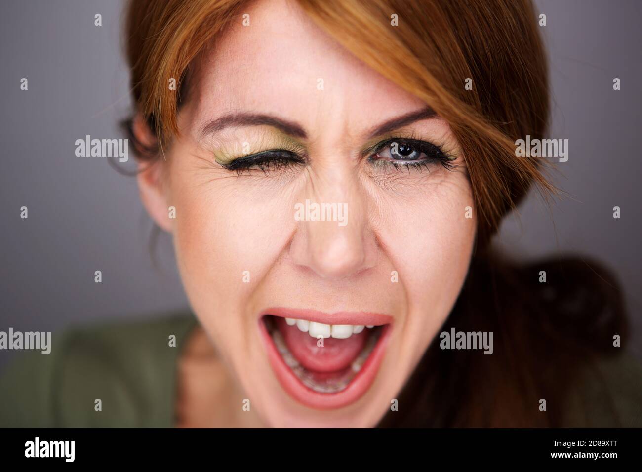 Close up portrait of cheerful middle aged woman winking eye Stock Photo ...