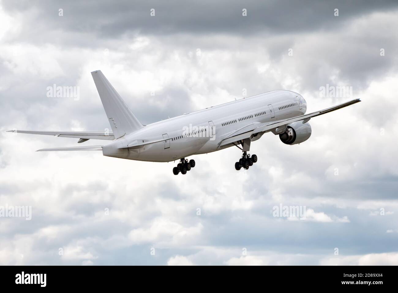 White wide-body passenger airplane in the air on take-off Stock Photo ...