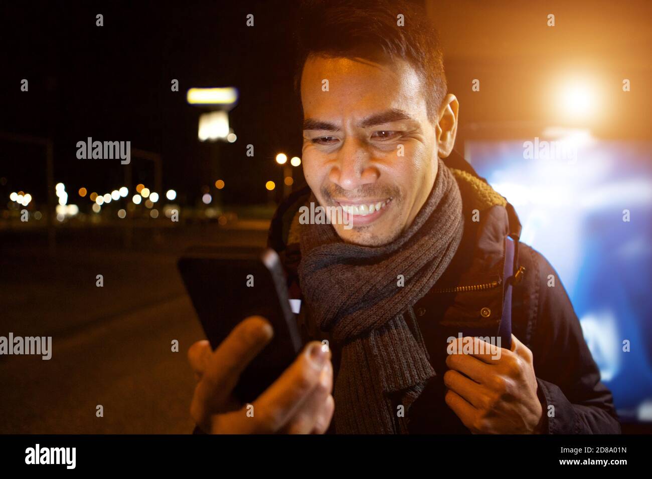 Happy man looking phone night hi-res stock photography and images - Alamy