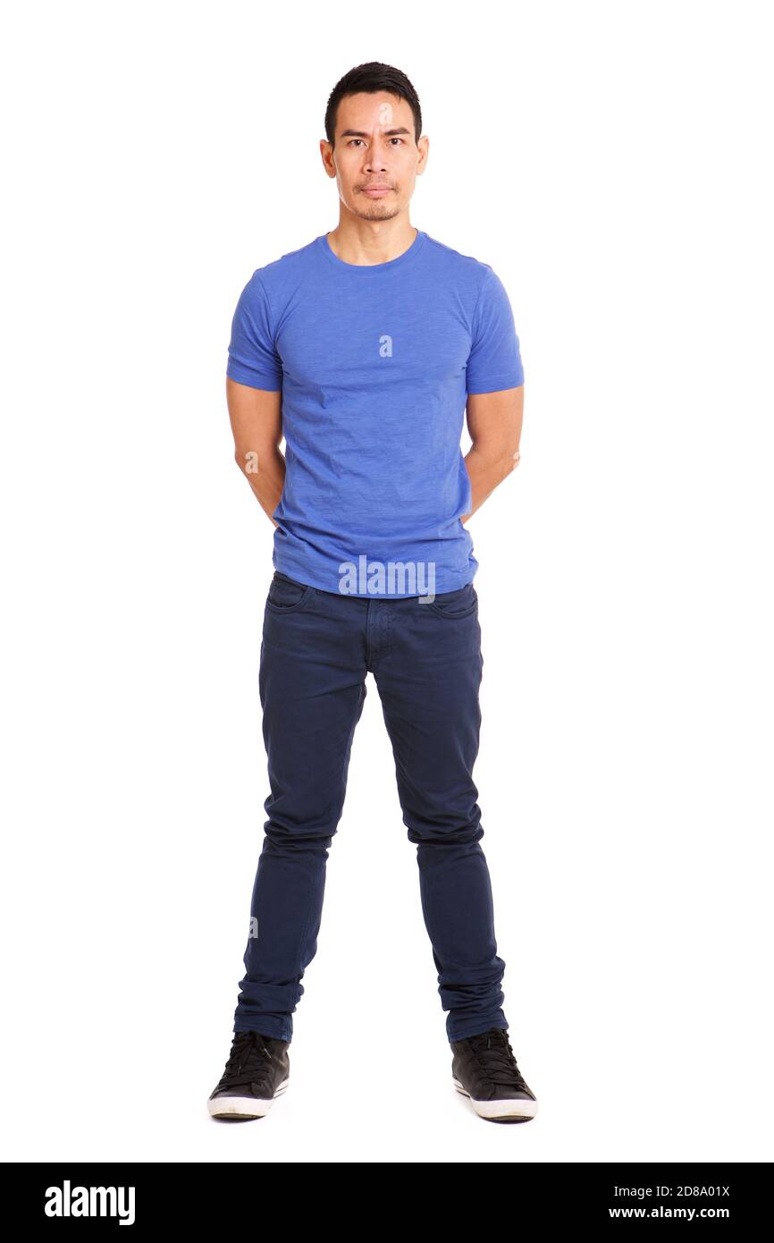 Full body portrait of handsome asian man standing with hands behind on ...