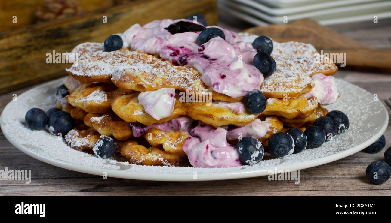 Waffle stack with blueberry cream on a plate Stock Photo - Alamy