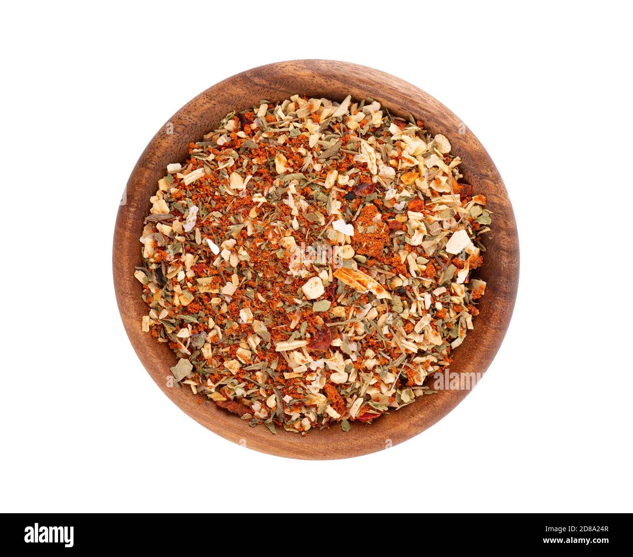 Mix of herbs, spices and dry tomatoes in wooden bowl, isolated on white ...