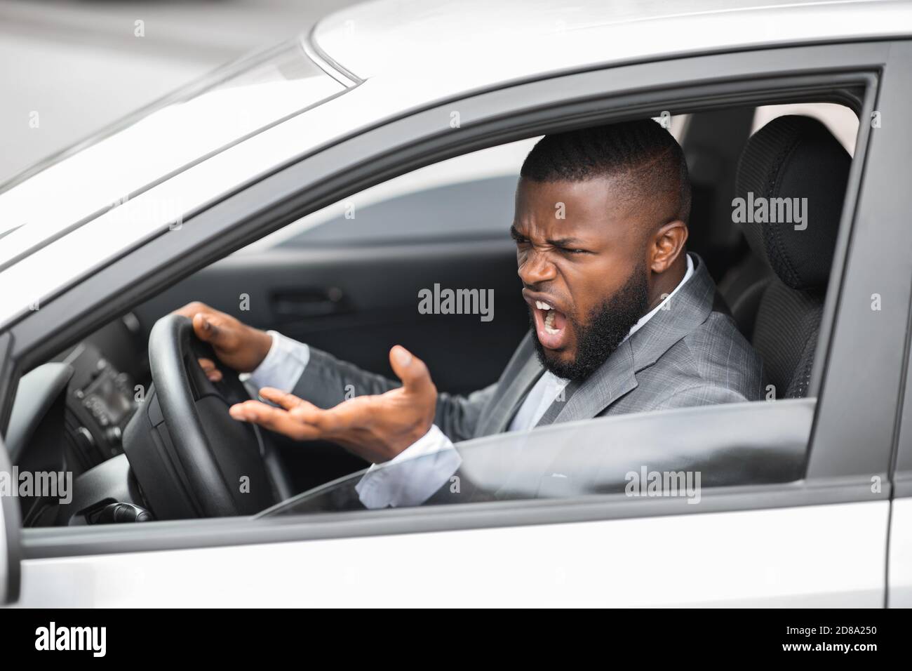 Angry black driver fighting on the road, stuck in traffic Stock Photo ...