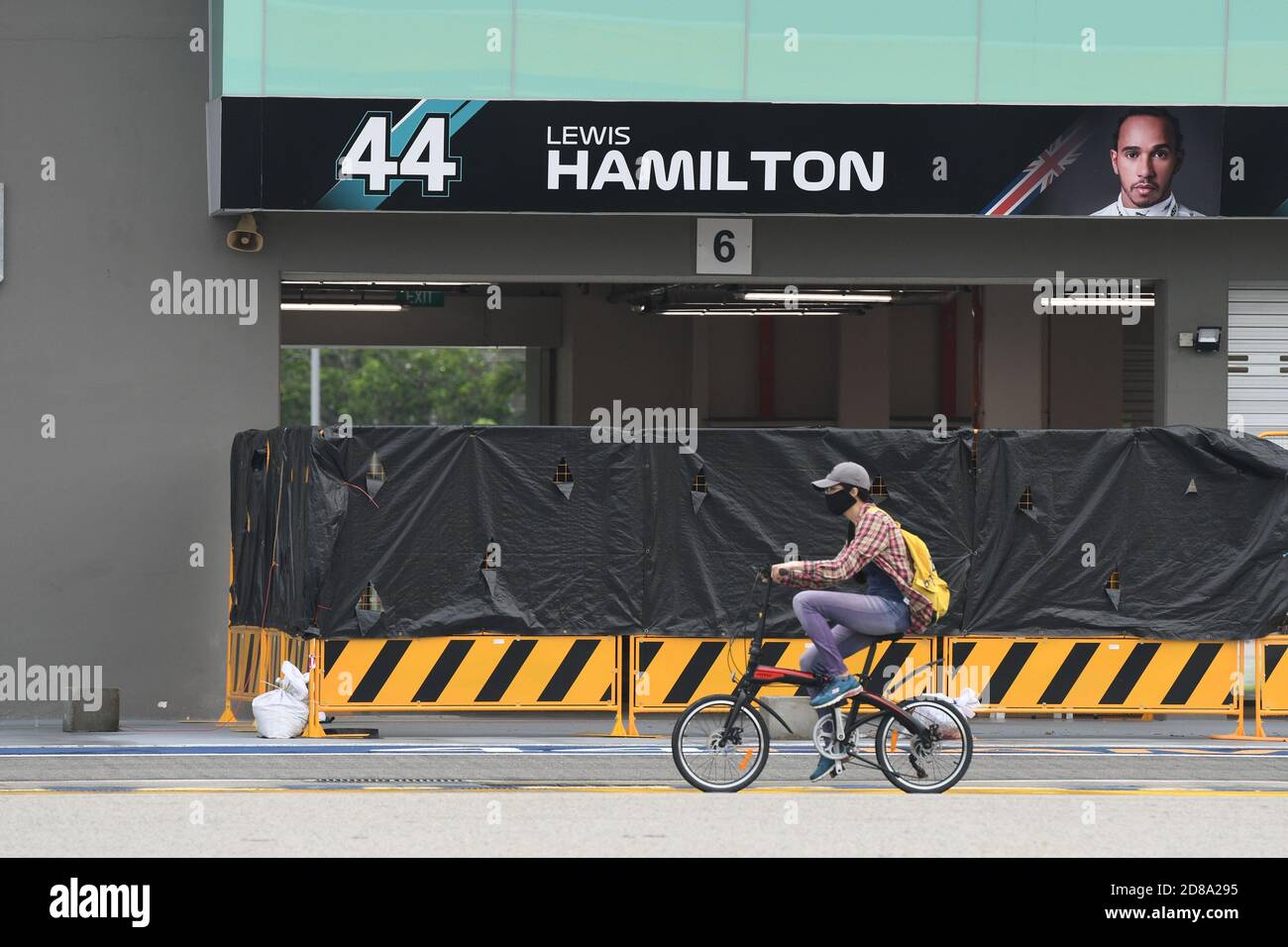 Singapore. 28th Oct, 2020. A man cycles past the F1 pit building after ...