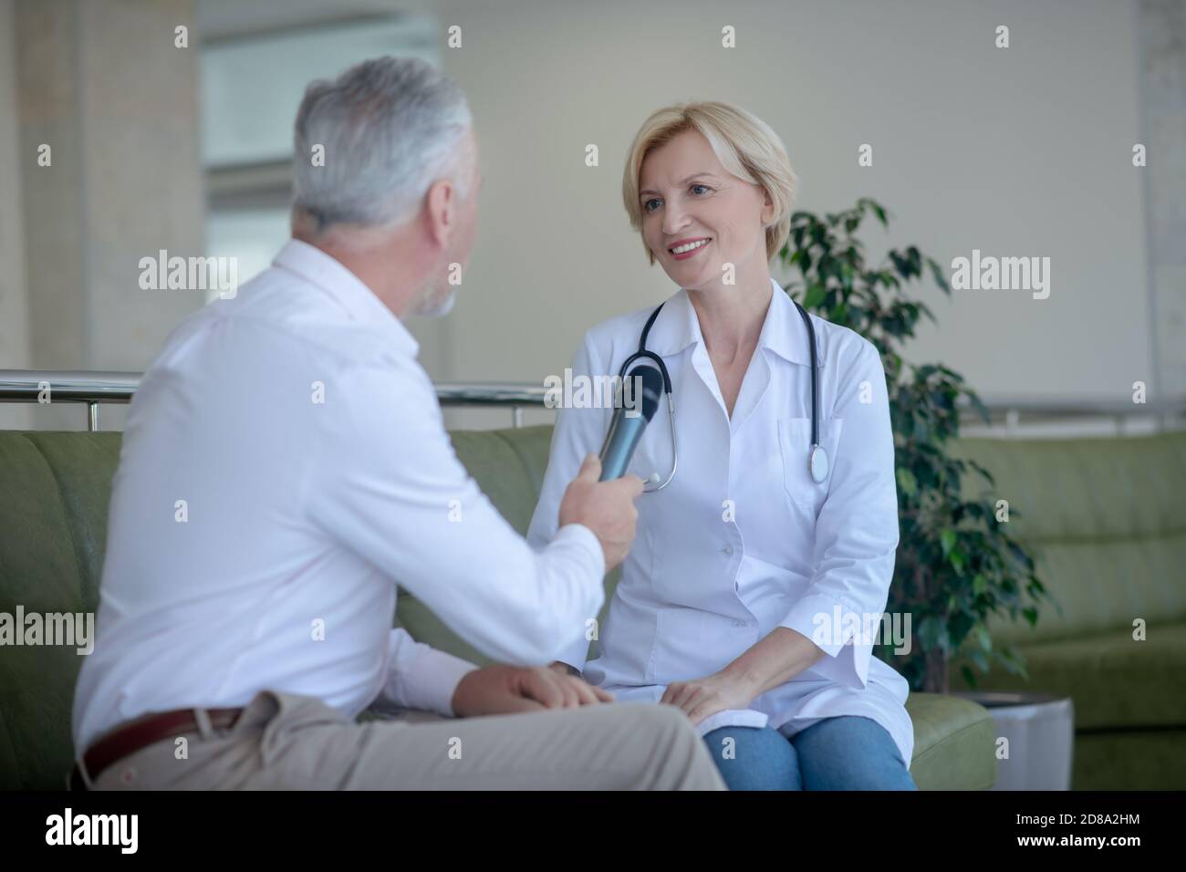 Mature woman asking questions doctor hi-res stock photography and ...