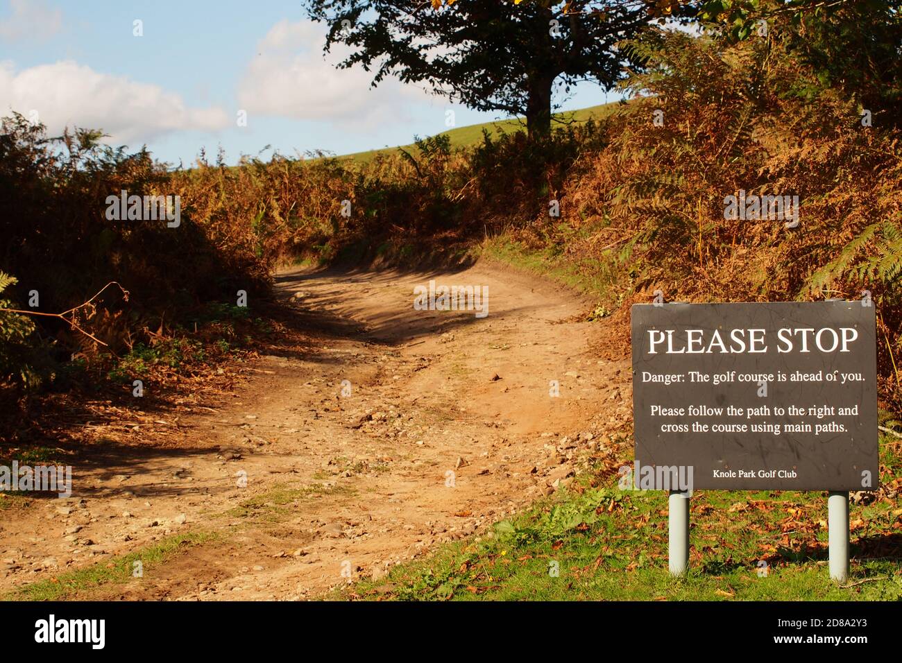 A warning stop sign to walkers of a golf course ahead, danger follow ...