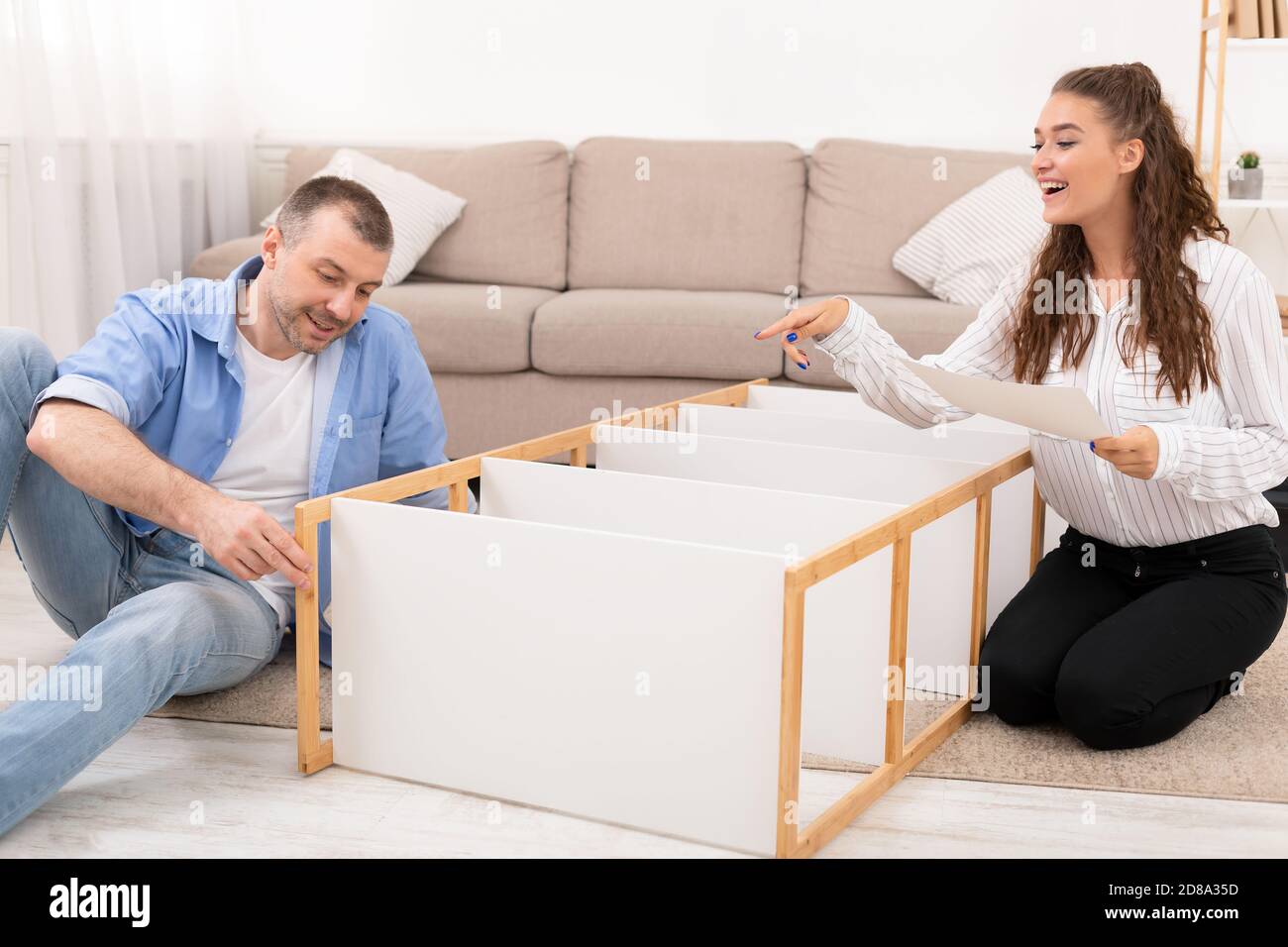 Happy Family Couple Installing Cabinet Shelf Together Furnishing New ...