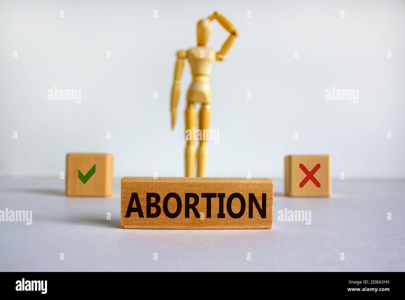 'Abortion' word written in wooden block. Wooden model of a man ...