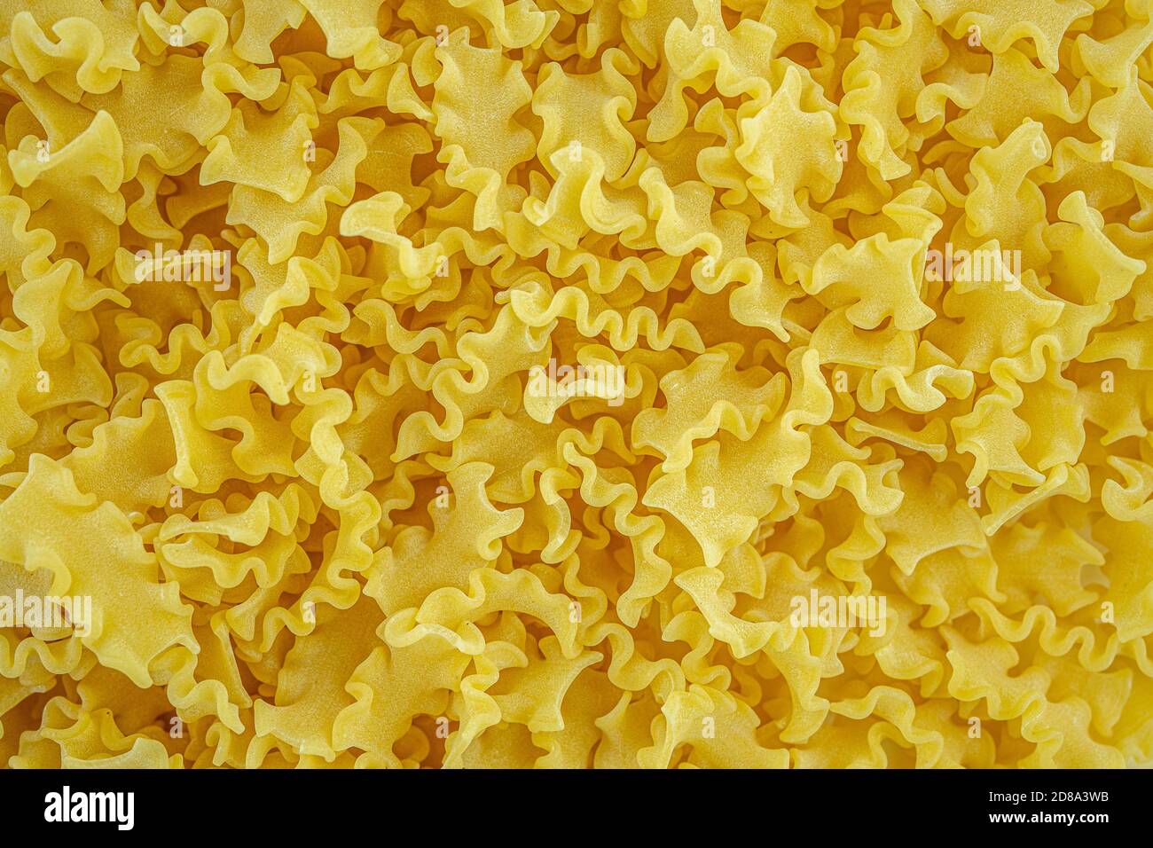 Italian dry wavy pasta background. Healthy traditional food. Top view ...