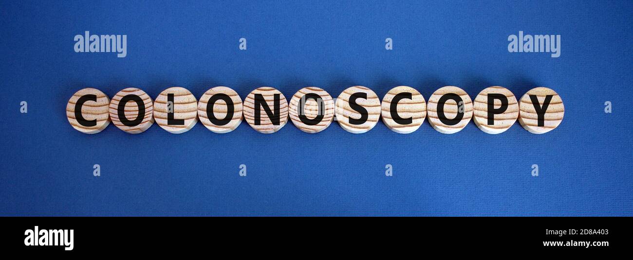 Wooden circles with word 'colonoscopy'. Beautiful blue background ...