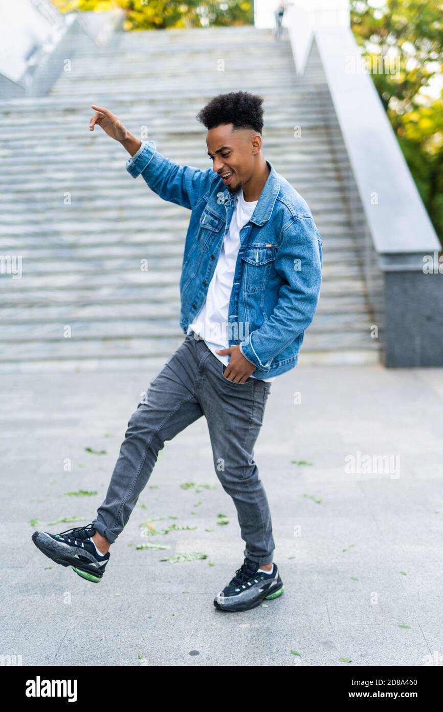 Portrait of young african man dancing outdoor in city centre Stock ...