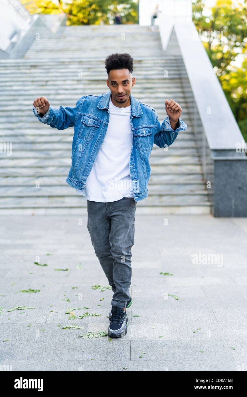 Portrait of young african man dancing outdoor in city centre Stock ...