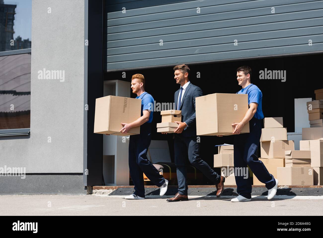 Man walking with boxes hi-res stock photography and images - Alamy