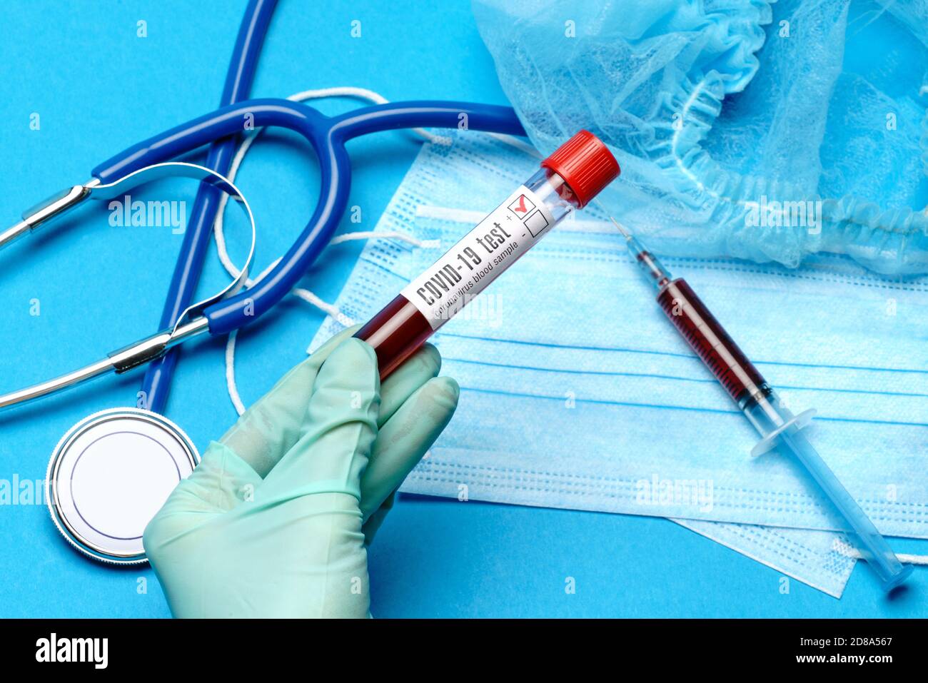 lab technician assistant or doctor holding a blood sample in test tube ...