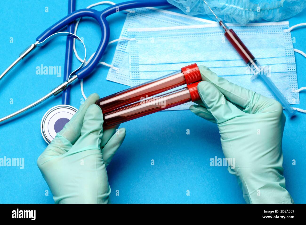 lab technician assistant or doctor holding a blood sample in test tube ...
