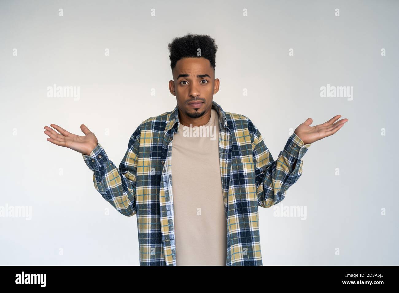 Portrait of young african american man gesturing do not know sign with ...