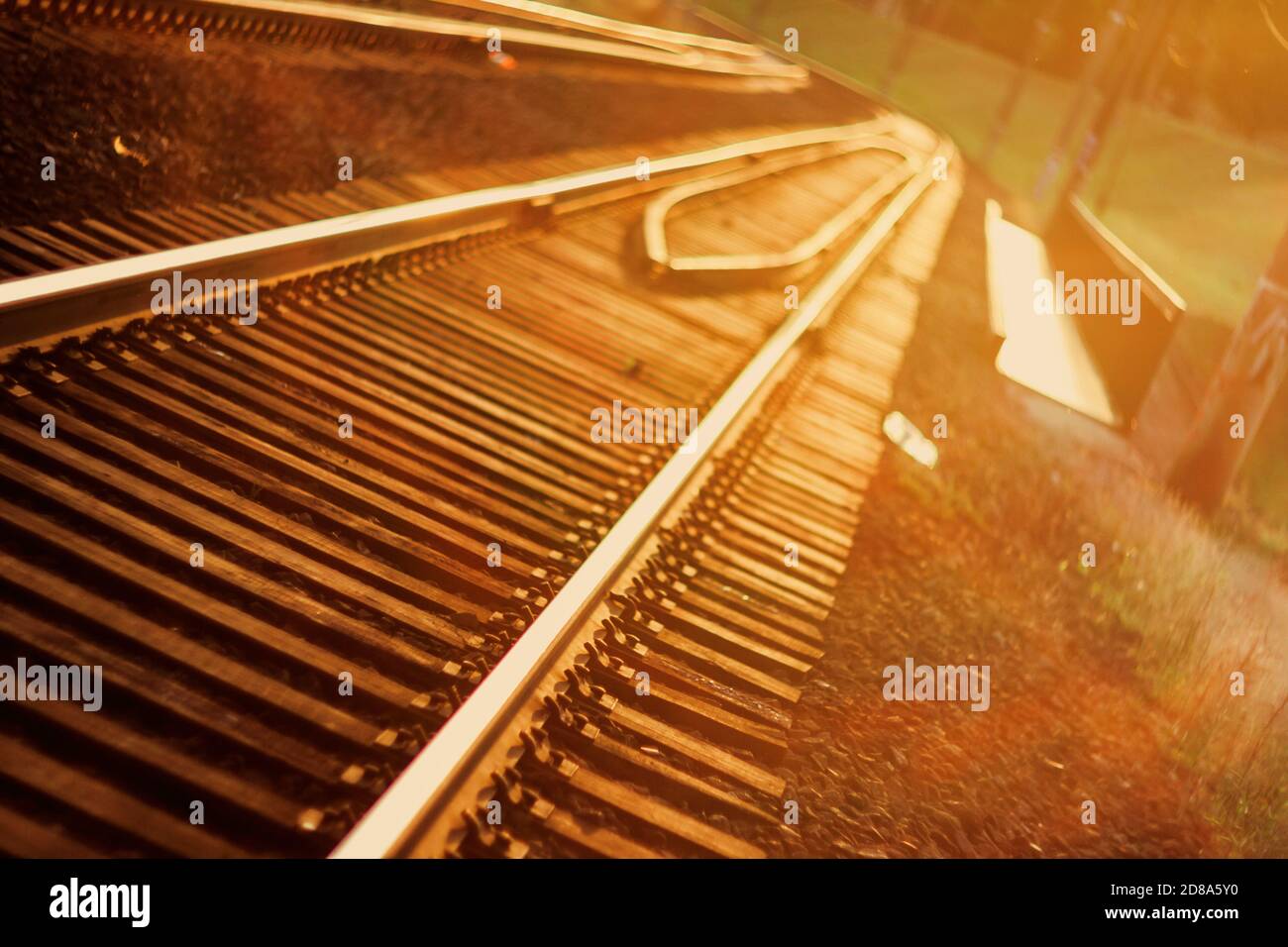 De focused curved railroad tracks in sunset with a lens flare Stock ...