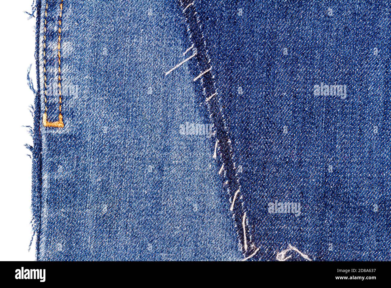 Piece of blue jeans fabric with a ripped of back pocket isolated on ...
