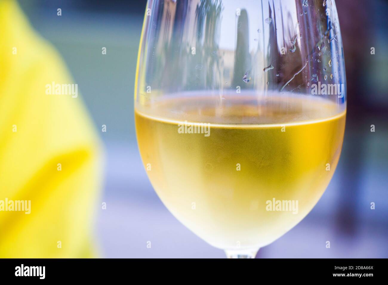 White wine in wineglass close-up background, yellow color Stock Photo ...