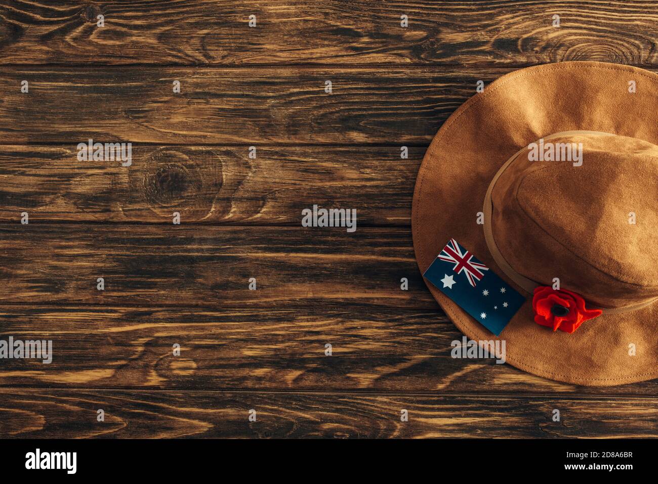 top view of felt hat, artificial flower and australian flag on wooden ...