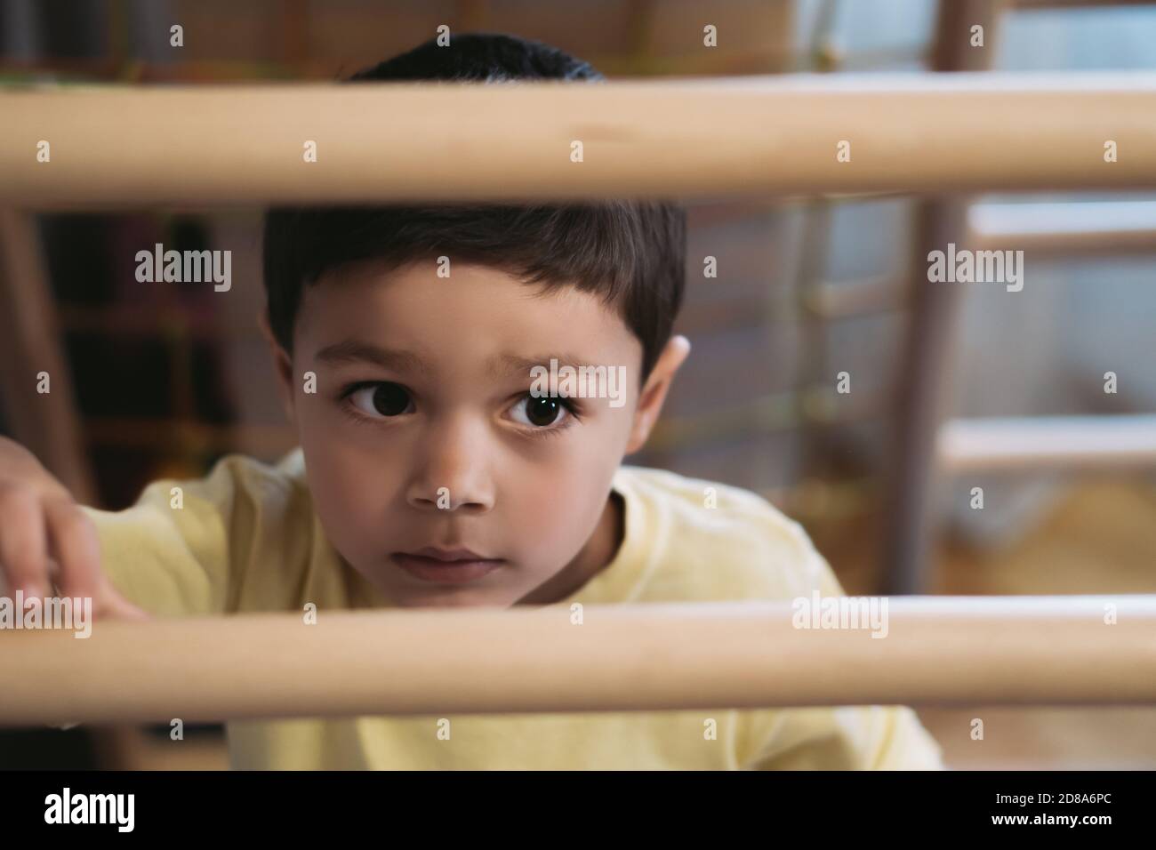 selective focus of cute boy climbing on ladder in home gym Stock Photo ...