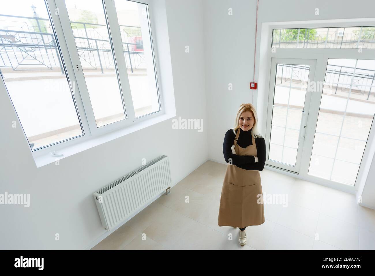 Pretty worker presenting open sign at the bakery Stock Photo - Alamy
