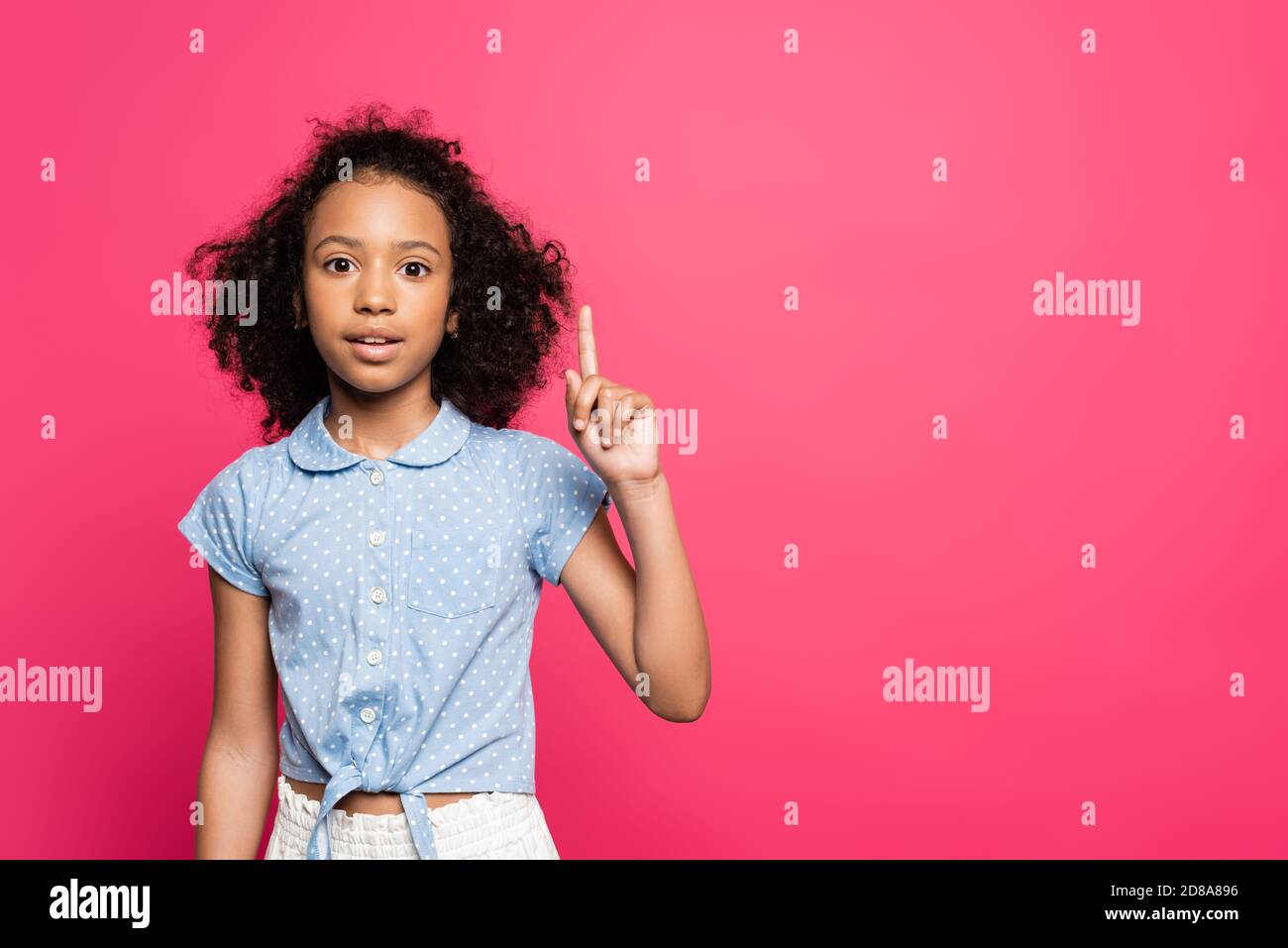 cute curly african american kid showing idea gesture isolated on pink ...