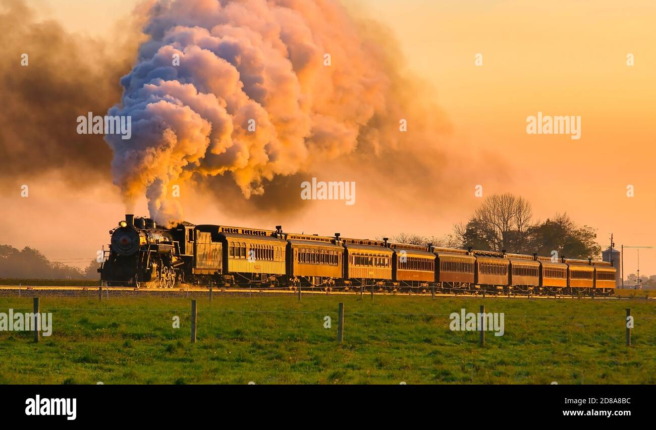 View of Golden Steam Passenger Train at Sunrise Traveling Thru Amish ...