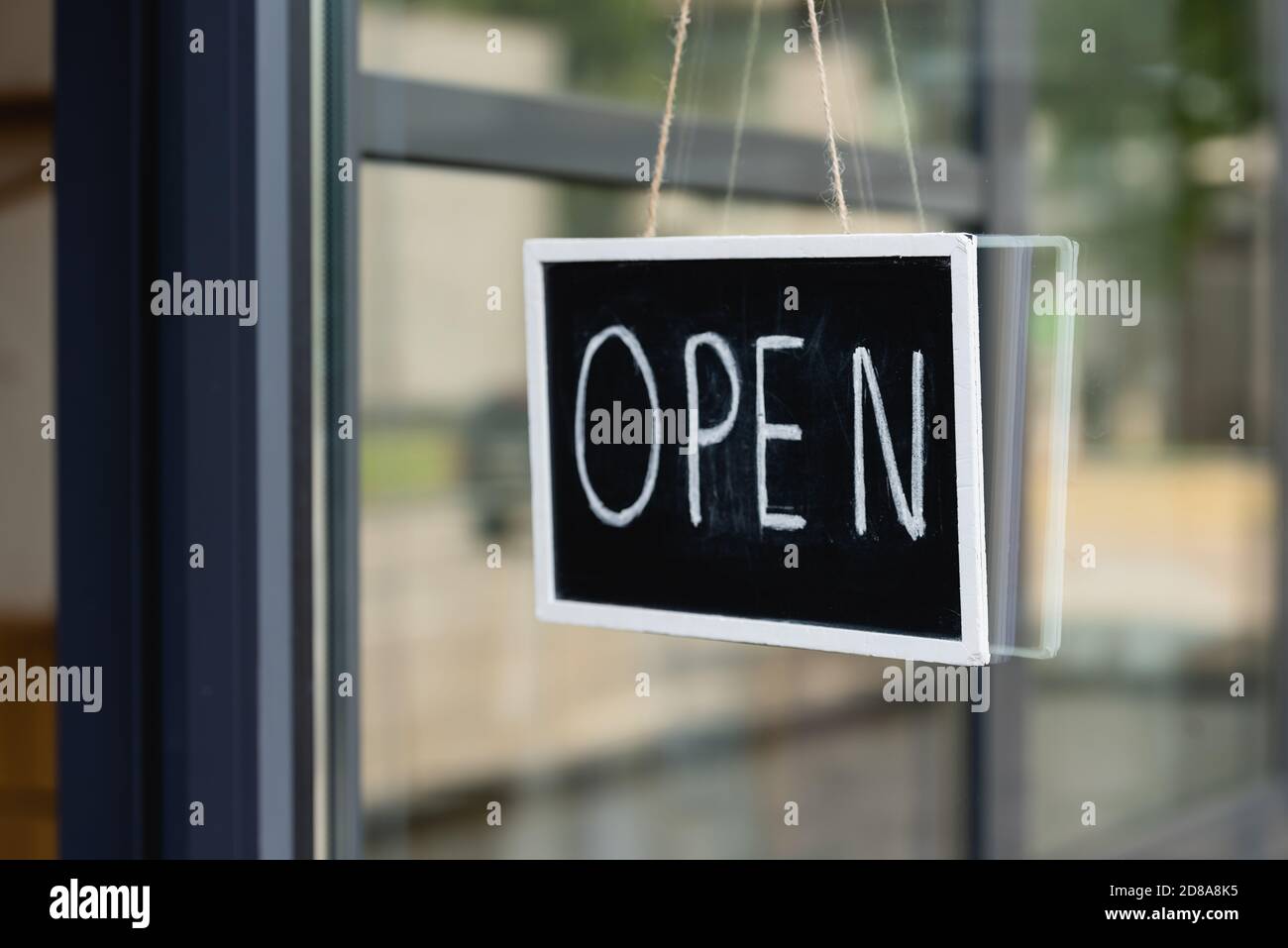 Signboard with open lettering on door of cafe Stock Photo - Alamy