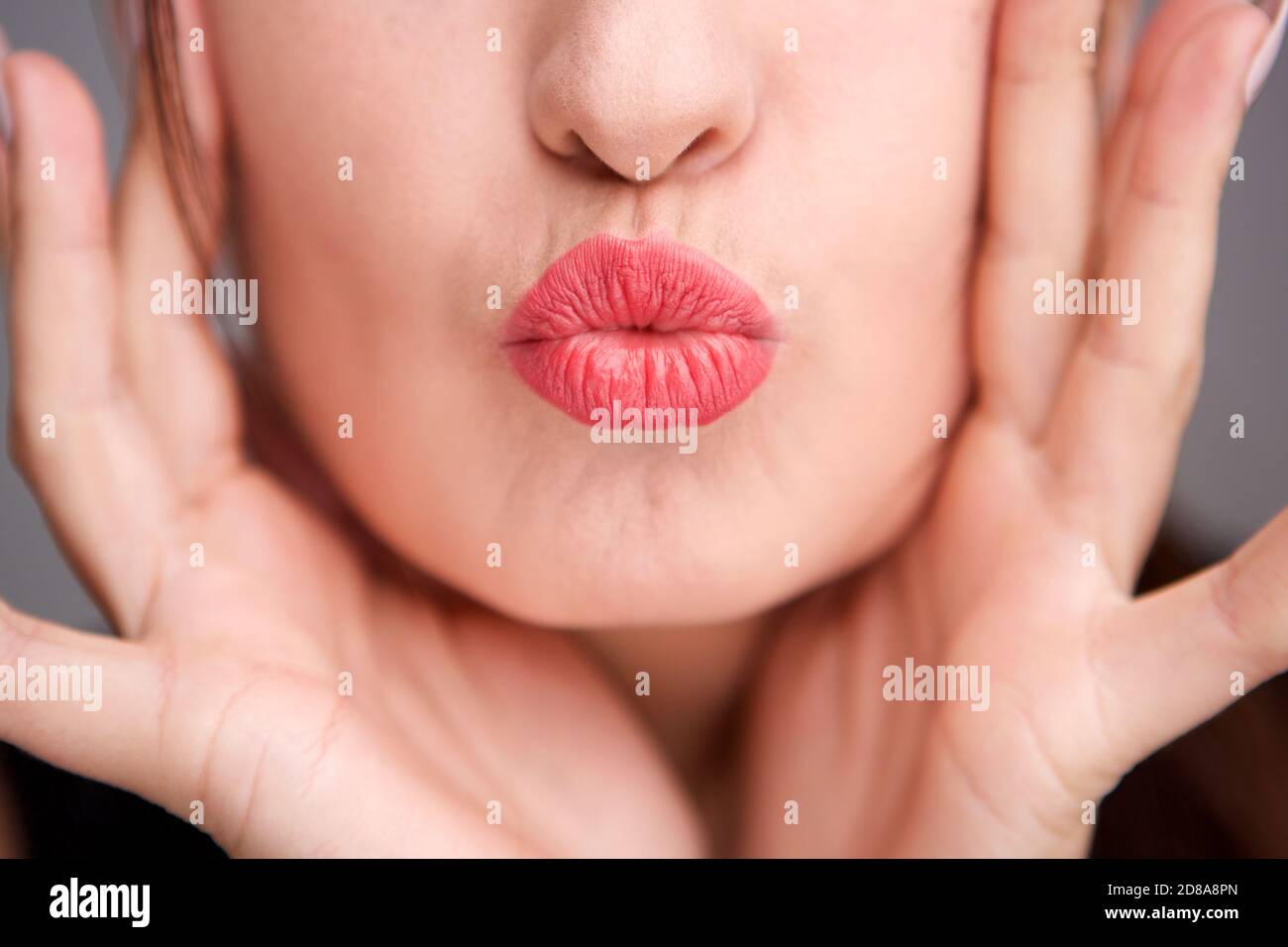 Close up portrait of young woman lips kissing Stock Photo - Alamy