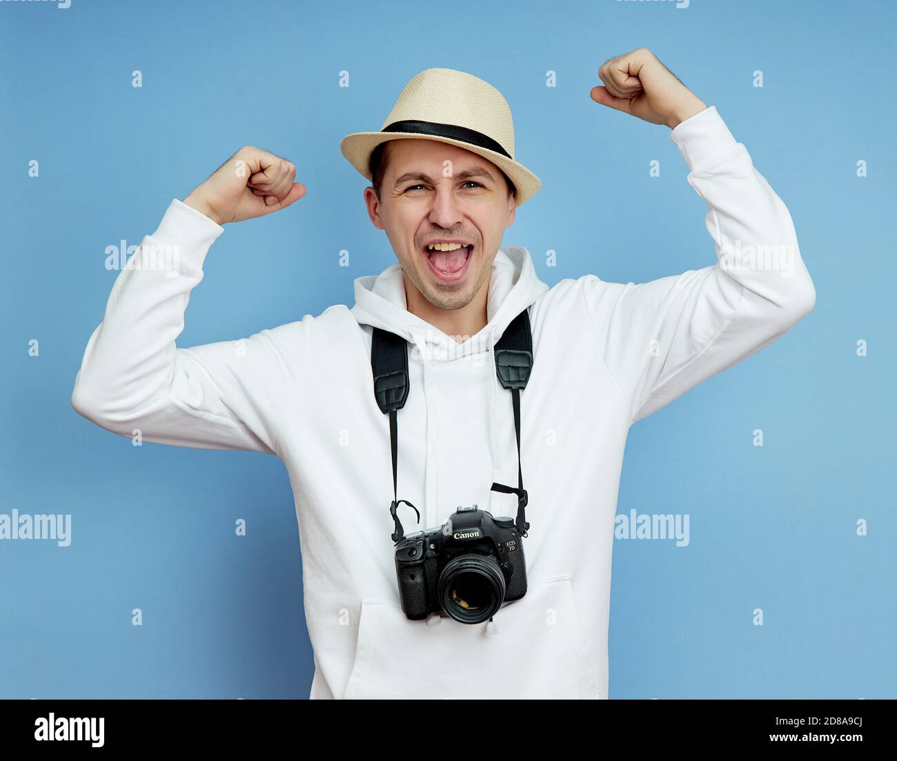 Man with a camera is happy, good luck and victory, euphoria Stock Photo ...