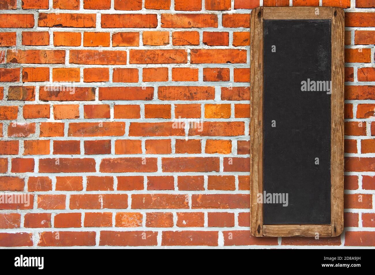 Red brick wall with vintage vertical blackboard sign Stock Photo - Alamy