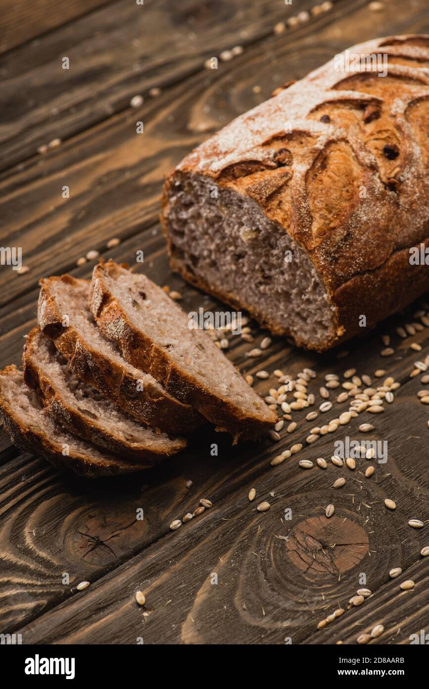 cut fresh baked bread with seeds on wooden surface Stock Photo - Alamy