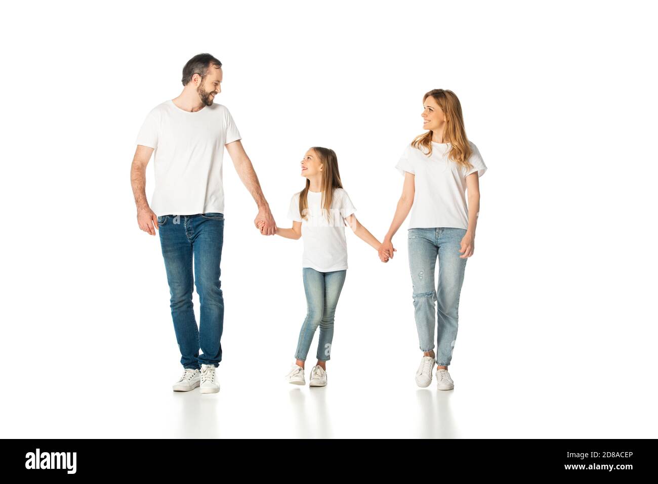 happy casual family holding hands while walking isolated on white Stock ...