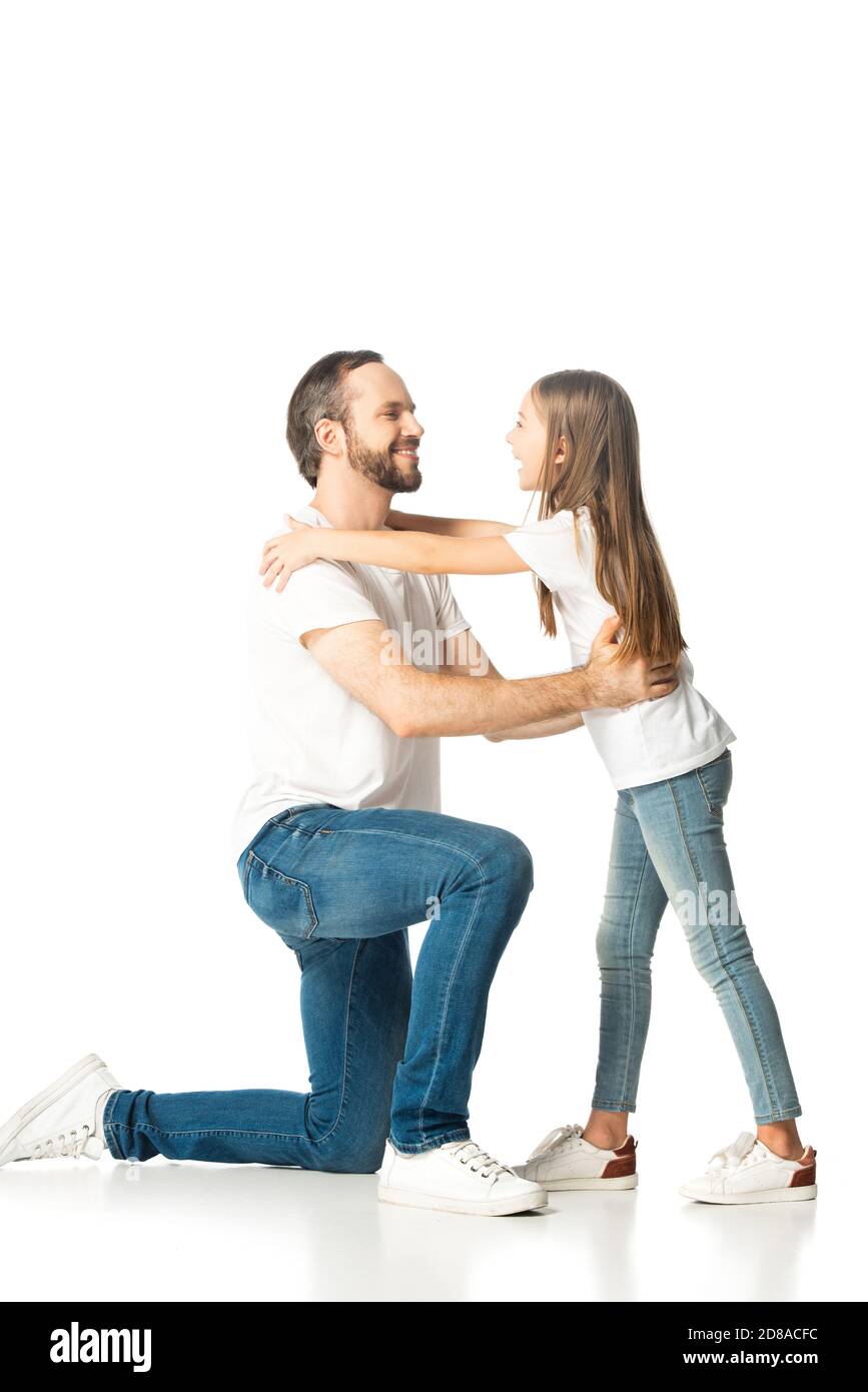 side view of father hugging happy daughter isolated on white Stock ...