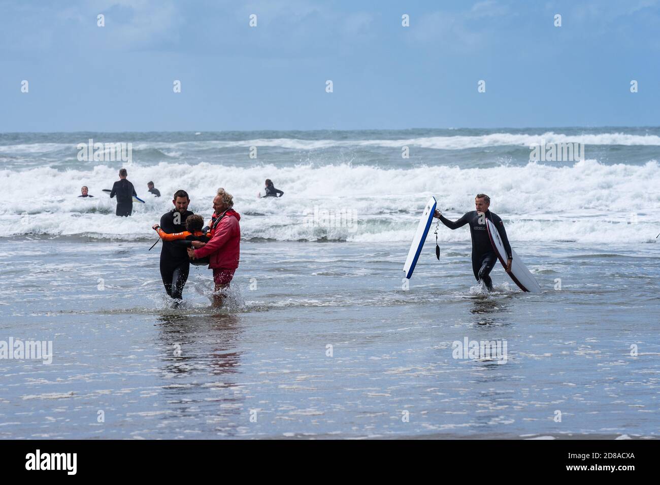 Bude, Cornwall UK July 6 2020. Lifeguards take out from the sea the ...