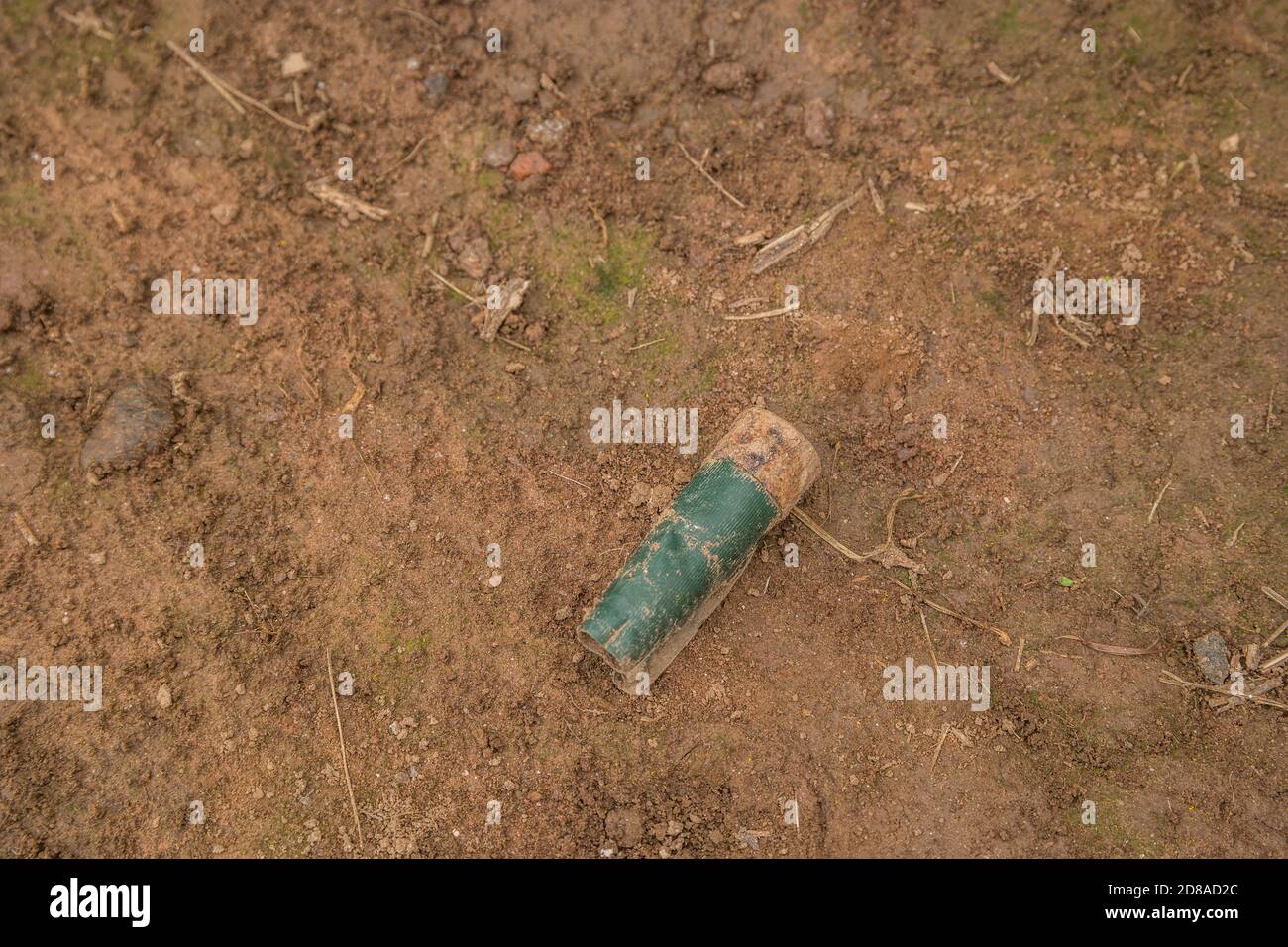 Used and empty old rusty shotgun shell left discarded from a firearm ...
