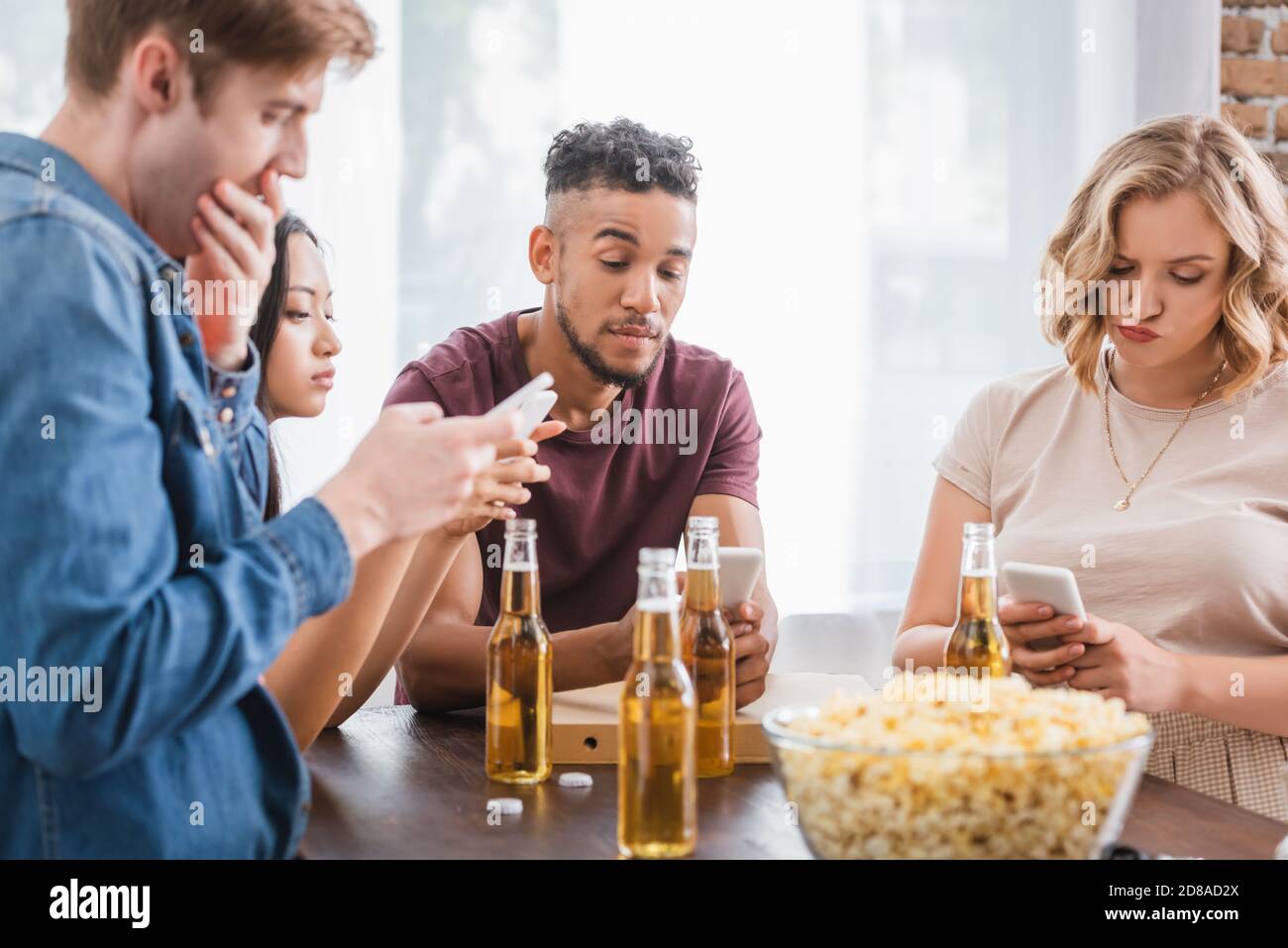 selective focus of multiethnic friends chatting on mobile phones near ...