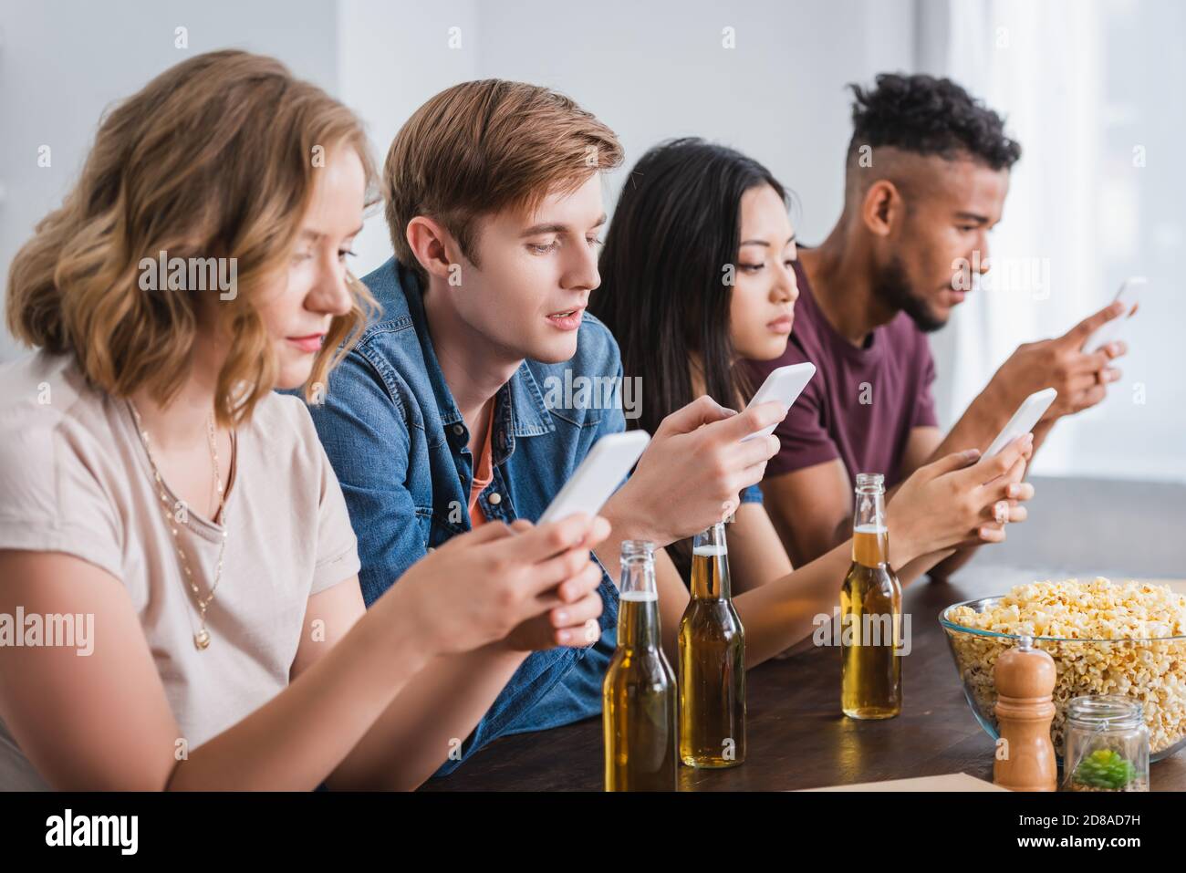 selective focus of multicultural friends chatting on mobile phones ...